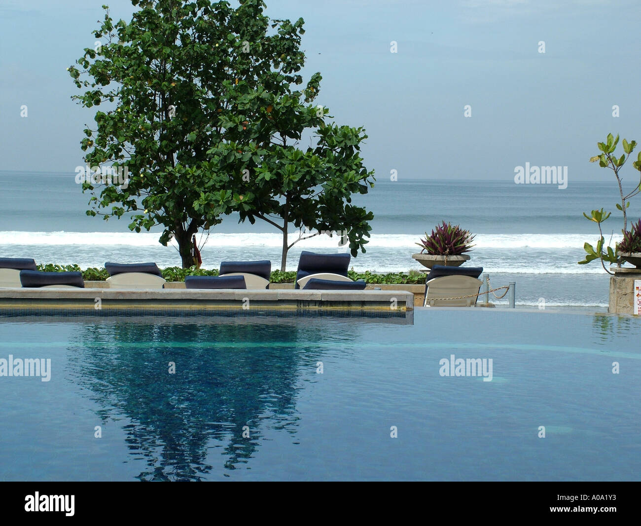 Beachside horizon pool and beach umbrellas, Balinese Hotel Resort Bali ...