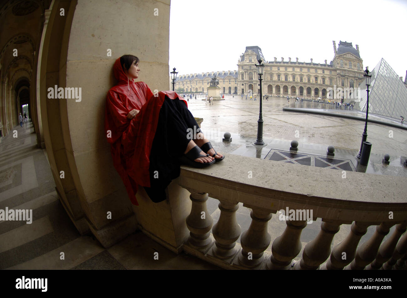 red raincoat girl in the rain at the louvre Stock Photo - Alamy