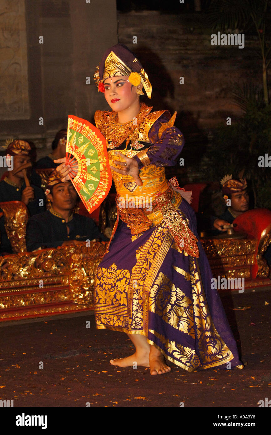Female Balinese Legong Dancer performing Taruna Jaya dance with fan ...