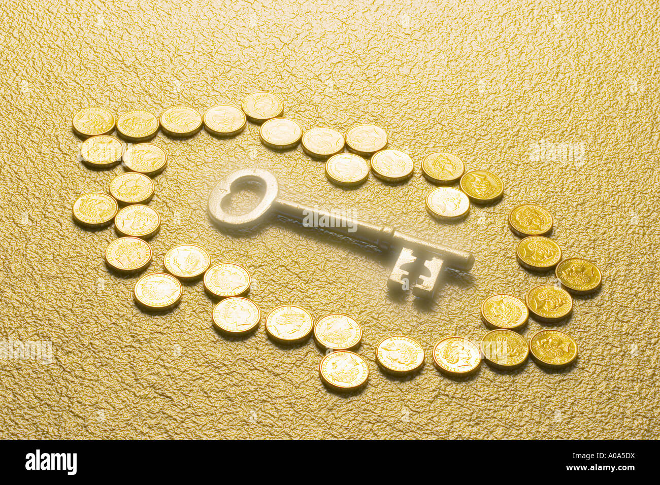 Coins and Skeleton Key Stock Photo - Alamy