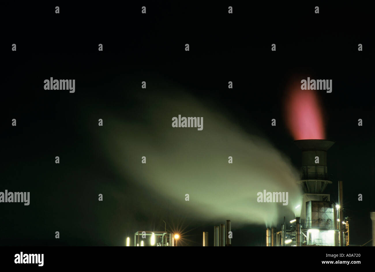 Illuminated chimney at a petroleum oil refinery Stock Photo - Alamy