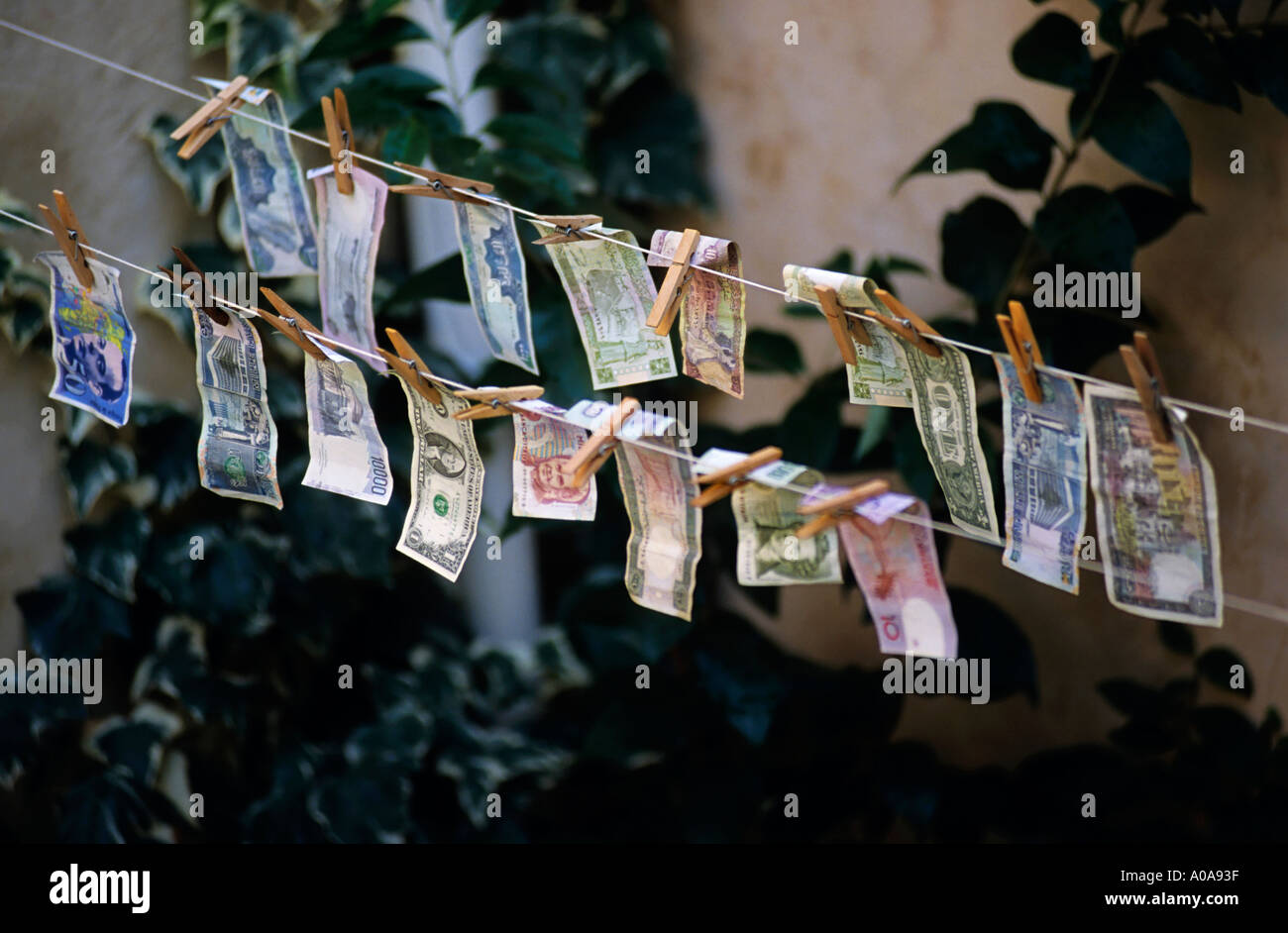 International Banknotes on a washing line - money laundering financial ...