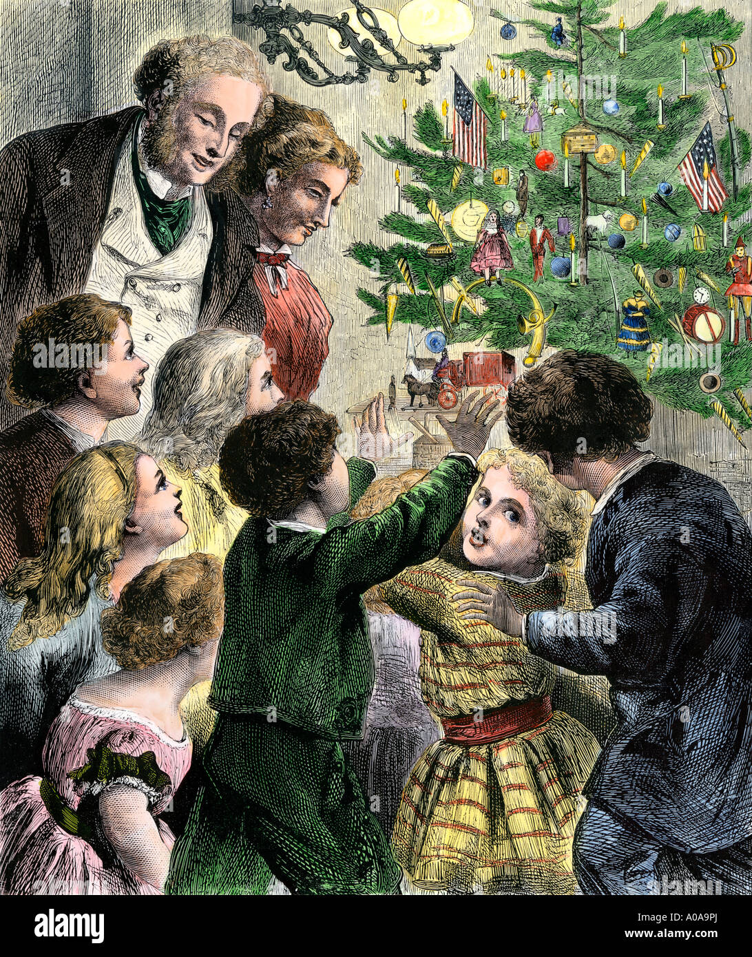 Children finding gifts on the family Christmas tree 1870s. Hand colored woodcut Stock Photo Alamy