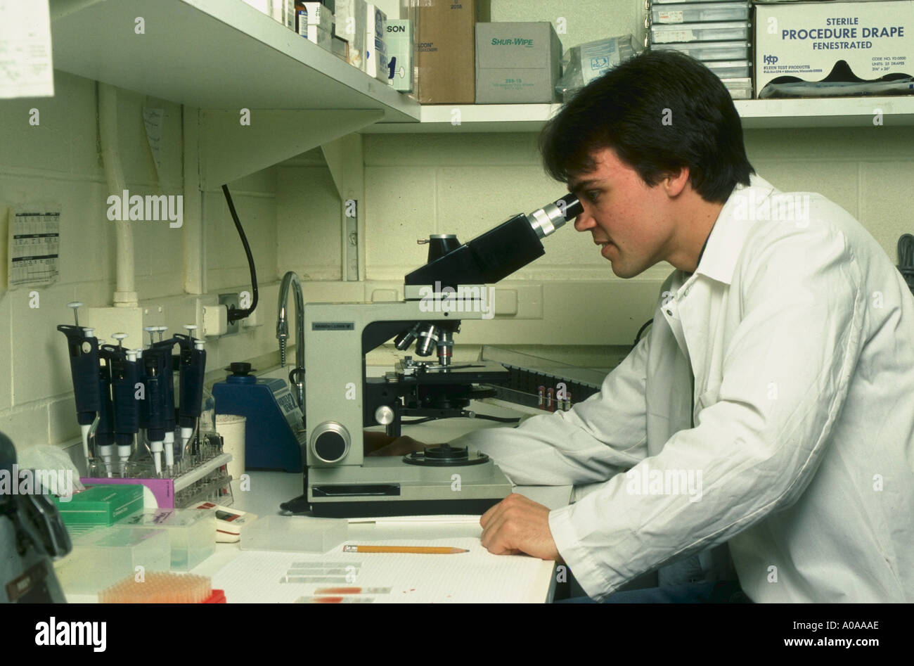 Man uses microscope in bio medical lab Stock Photo - Alamy