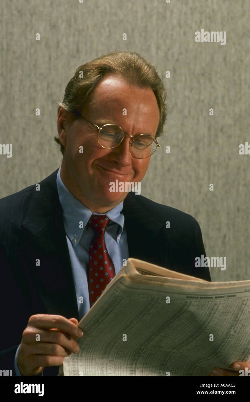 Businessman reading newspaper model released Stock Photo - Alamy