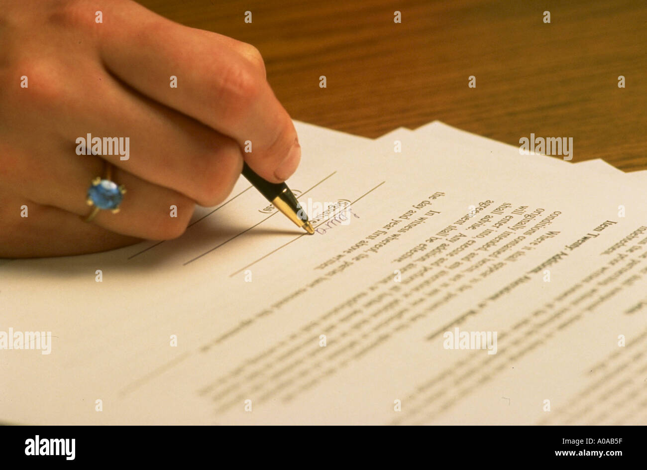 Woman signing contract Stock Photo - Alamy
