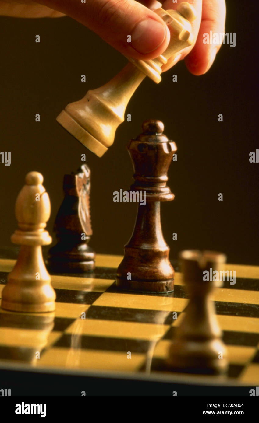 Hand holding chess pieces Stock Photo - Alamy