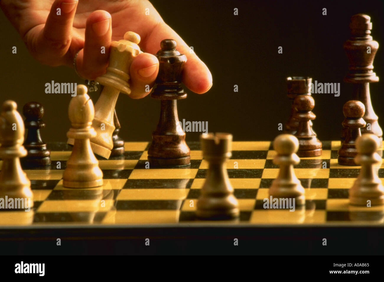 Hand holding chess pieces Stock Photo - Alamy