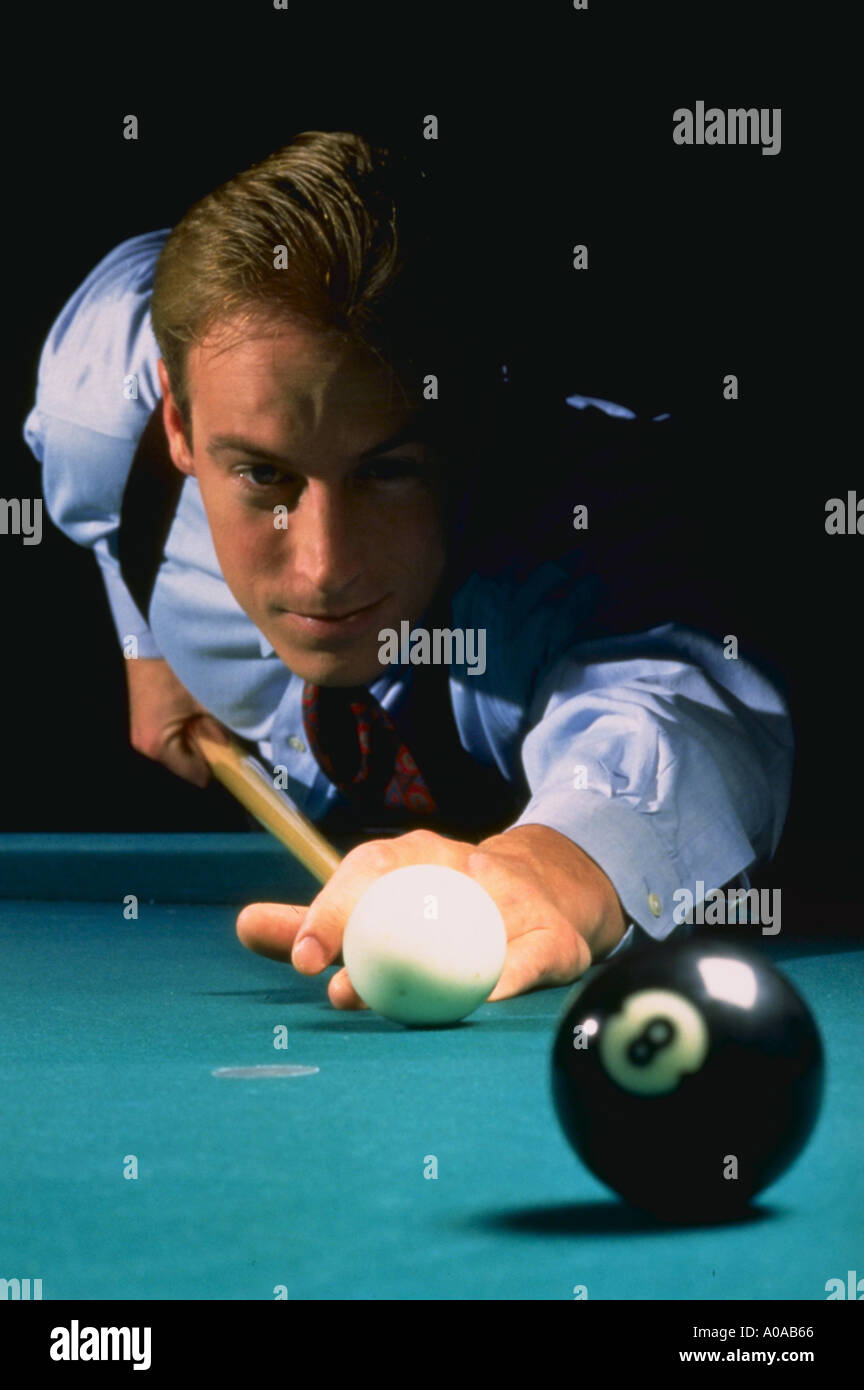 Business man playing pool shooting for the eight ball Stock Photo - Alamy