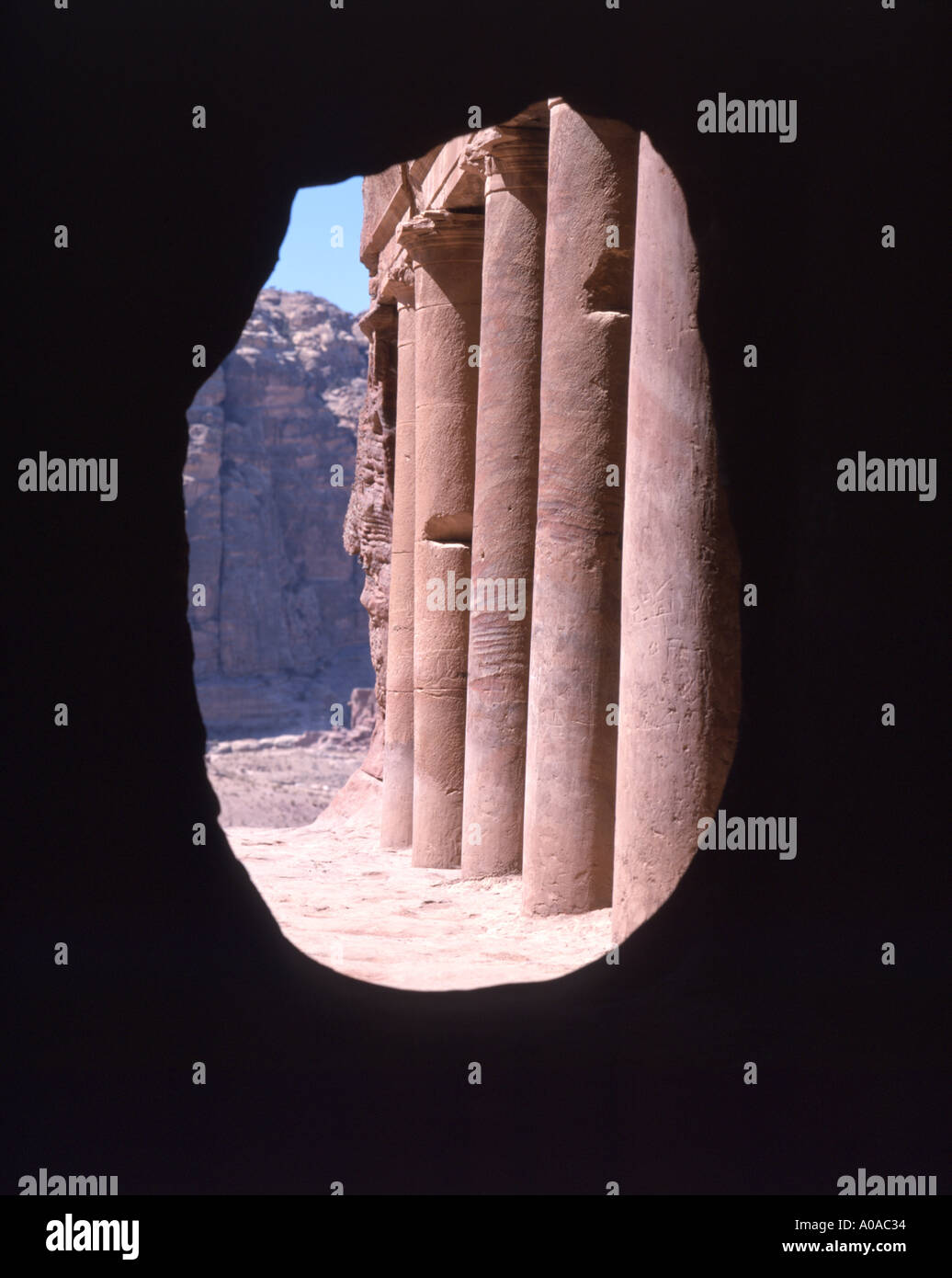 Looking through a window in a rock dwelling to a line of Roman pillars ...
