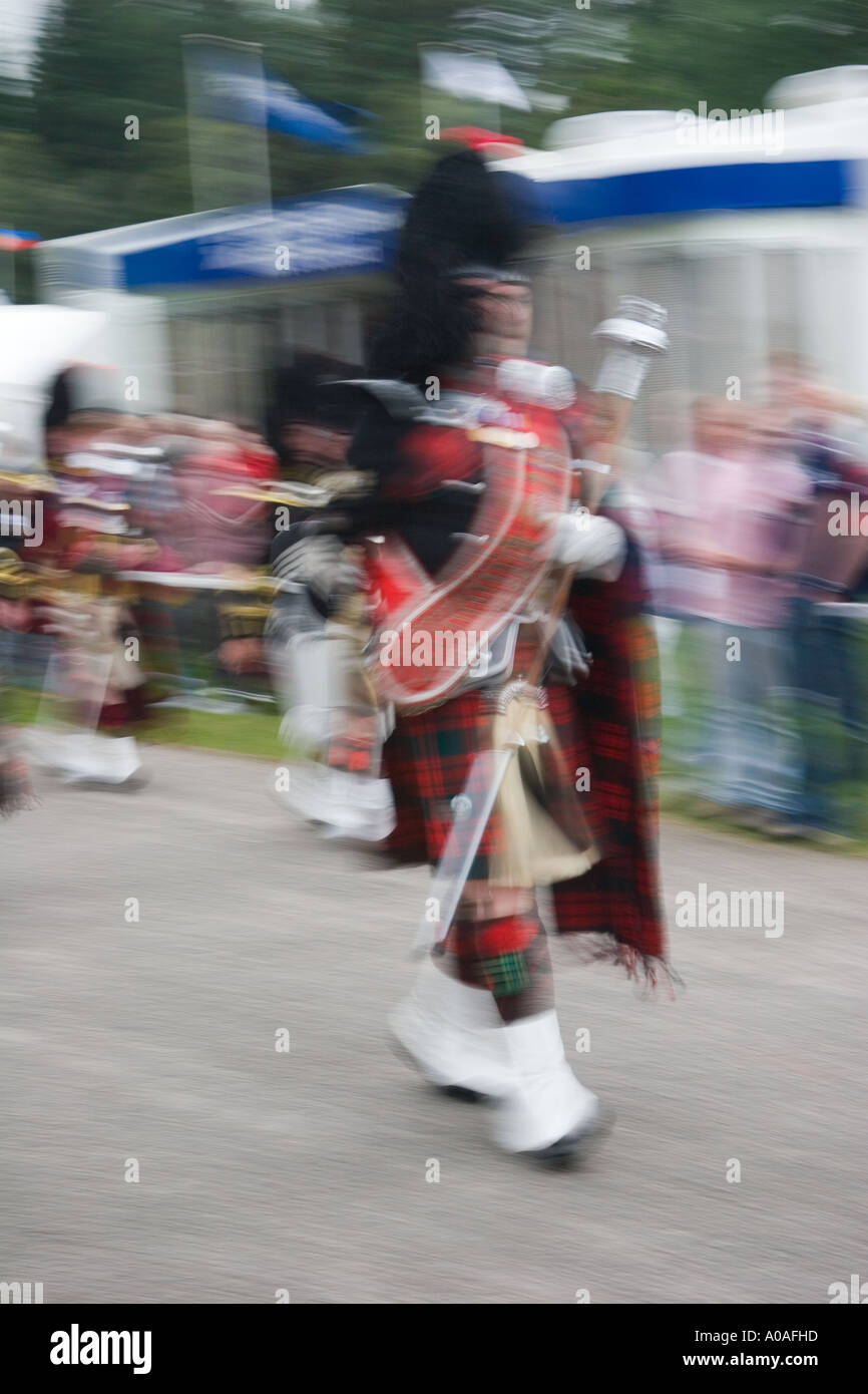 Blurred, out of focus Marching bands and Scottish piper at the Highland ...