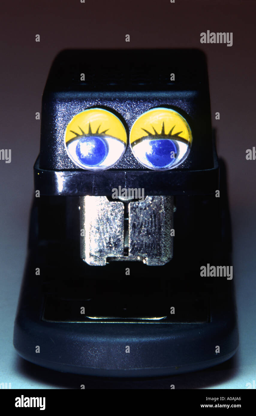 Black plastic stapler with comedy eyes attached Stock Photo - Alamy