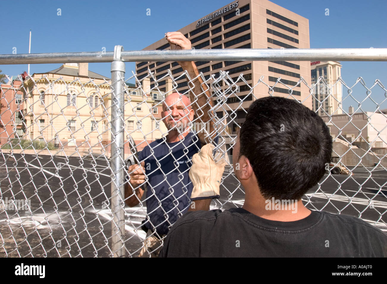 Middle age Spanish man and his teenage son working on the construction ...
