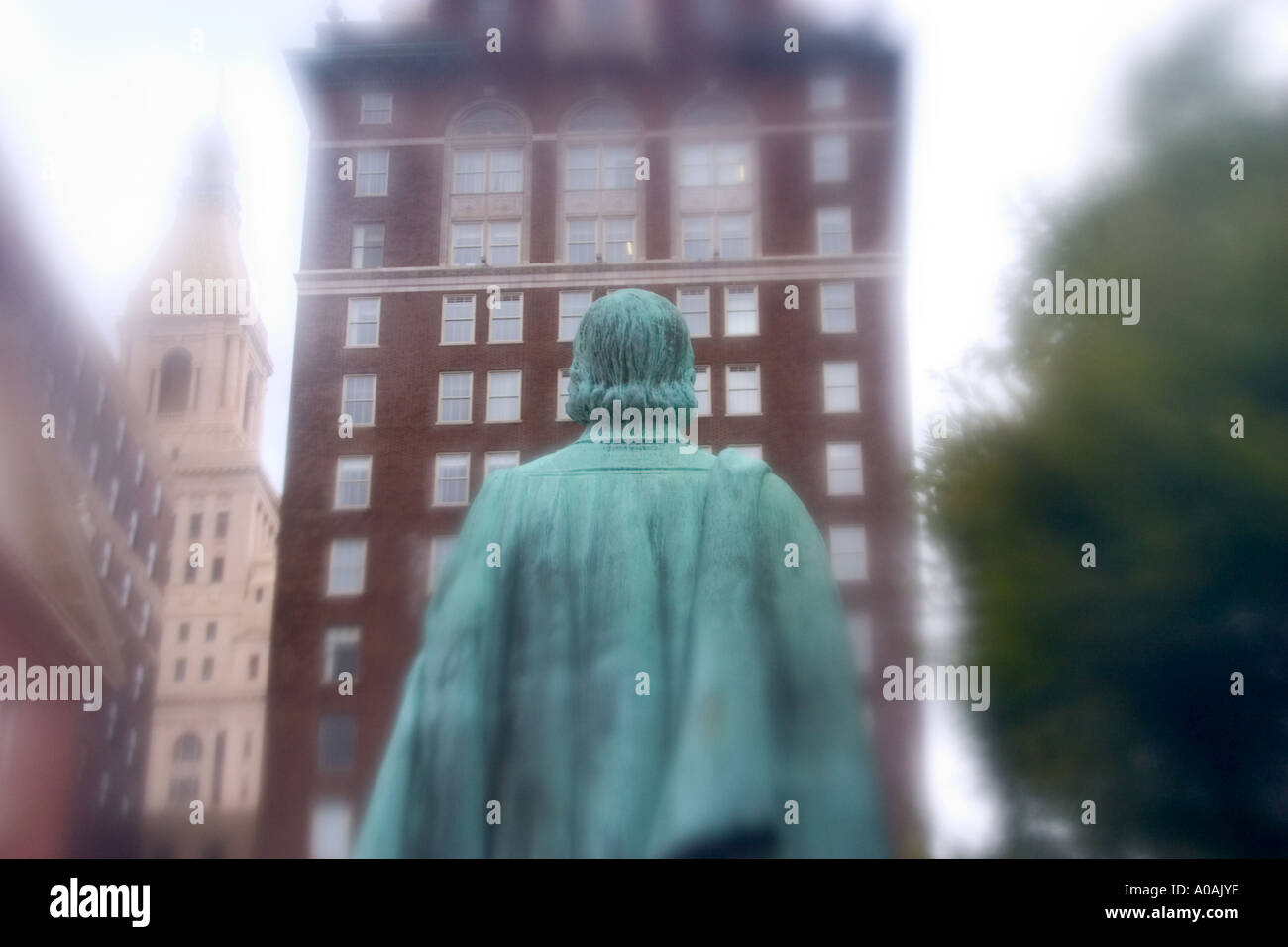 Back of a statue which is facing a downtown office building Stock Photo ...