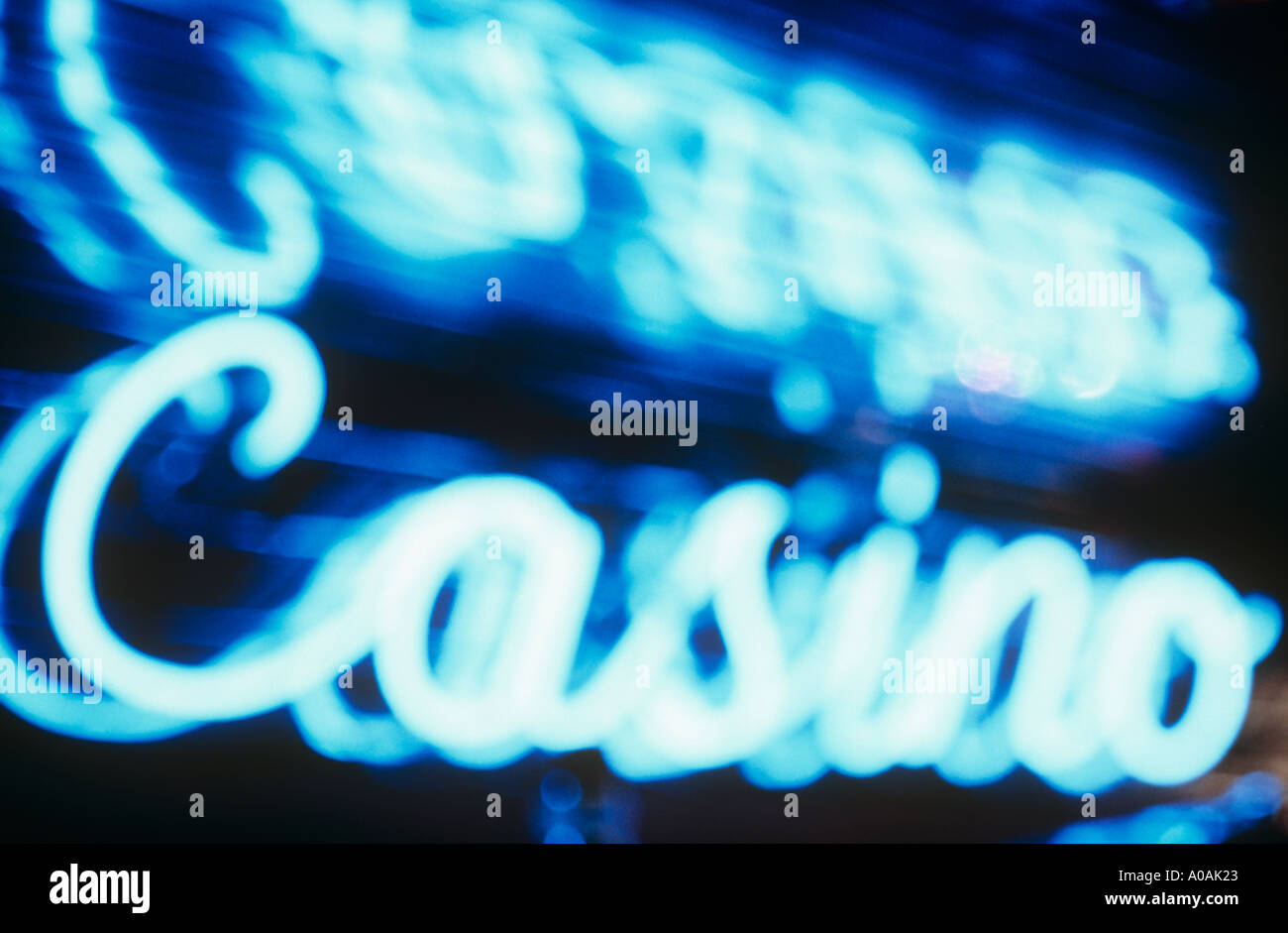 Defocussed cursive blue neon sign with mirror reflection stating Casino ...