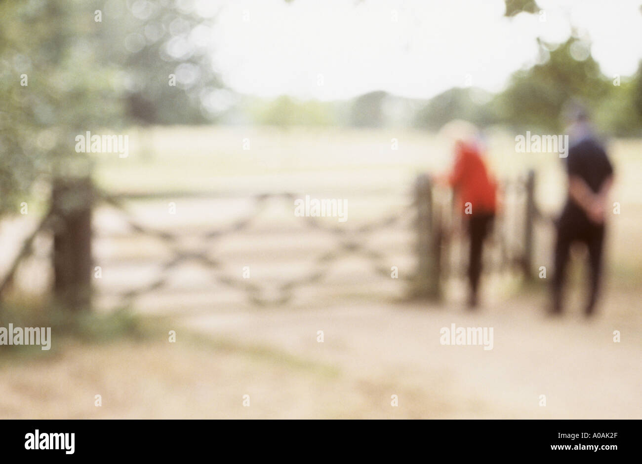 Two impressionistic figures about to pass through a pedestrian gate in ...