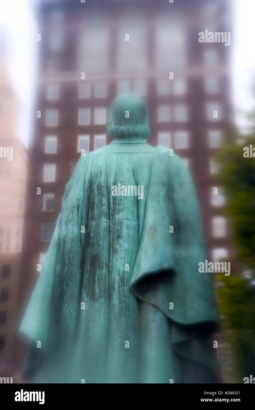 Back of a statue which is facing a downtown office building Stock Photo ...