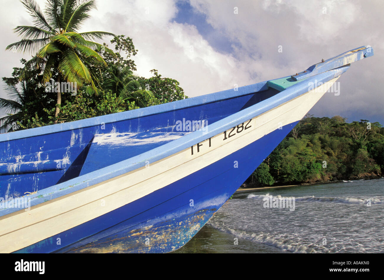 CARIBBEAN TOBAGO Bow of colorful fishing boat against ocean and ...