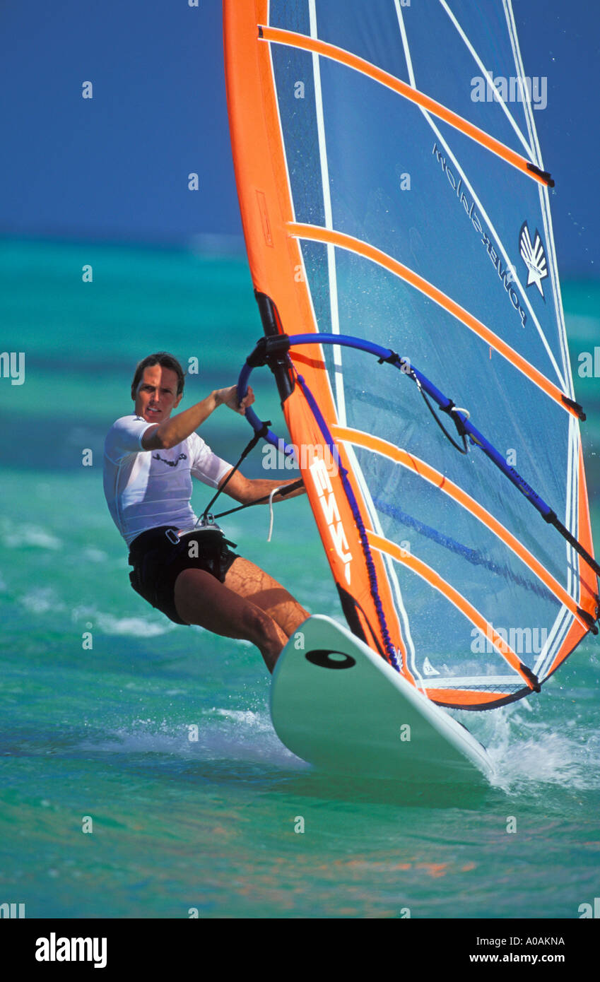 CARIBBEAN TRINIDAD TOBAGO Colorful wind surfers sailing on ocean blue ...