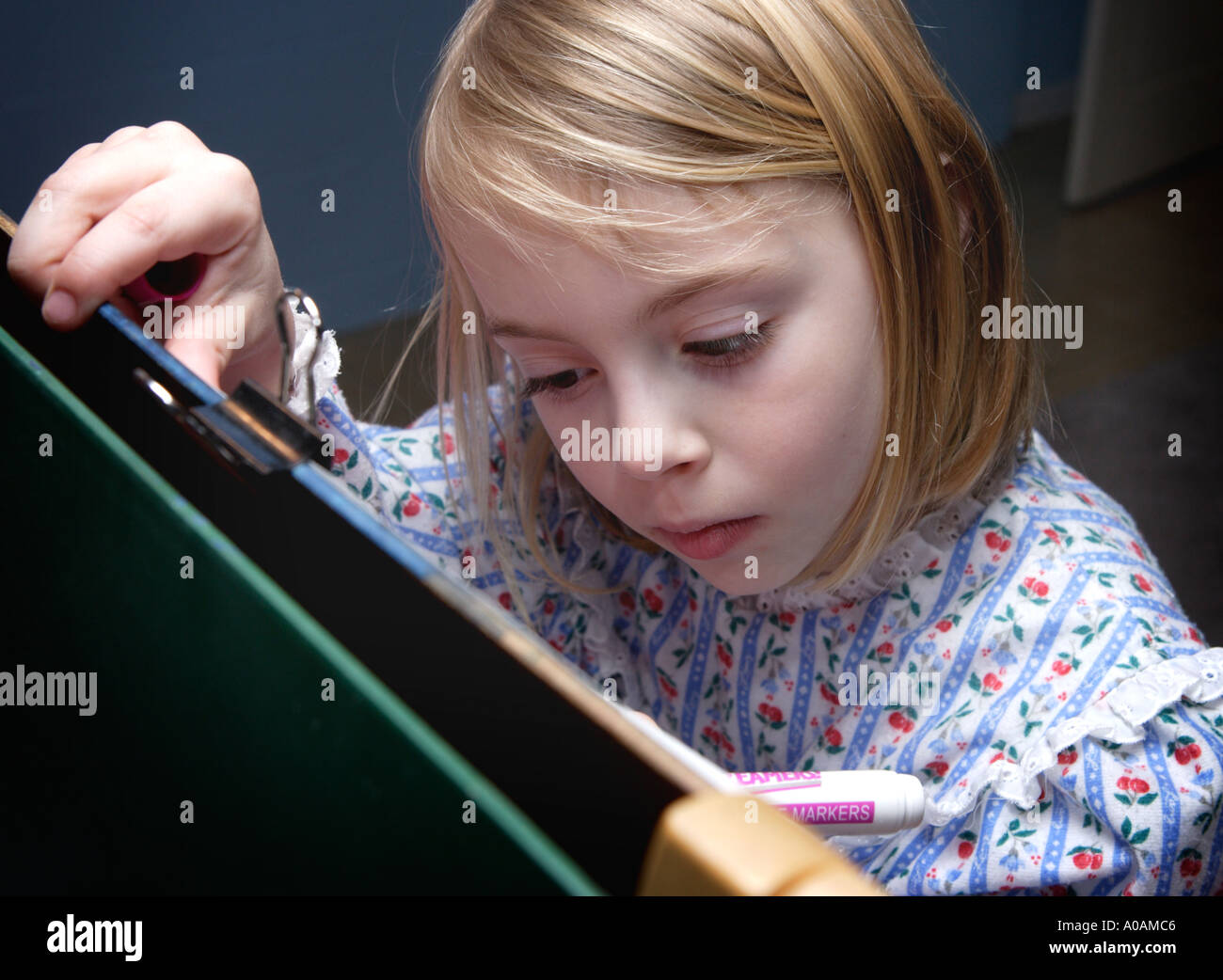 Child writing on an easel Stock Photo - Alamy
