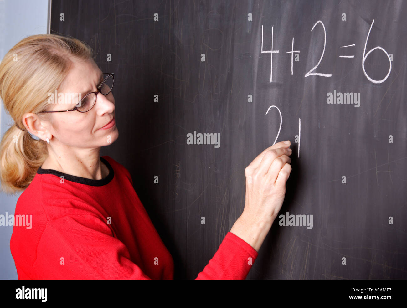 Math teacher writing on a blackboard Stock Photo - Alamy