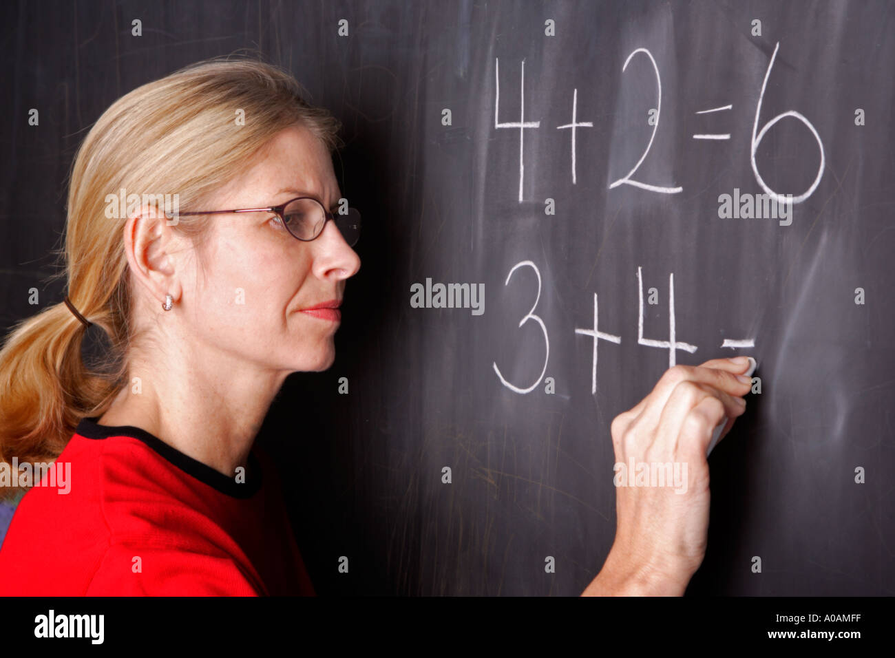 Math teacher writing on a blackboard Stock Photo - Alamy