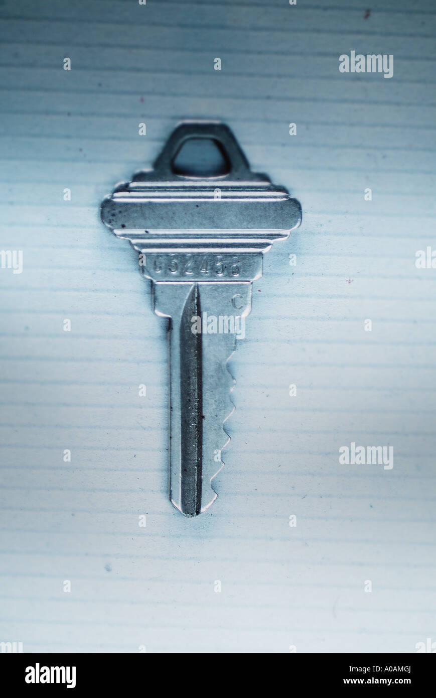 Single house key lying on home made paper surface Stock Photo - Alamy