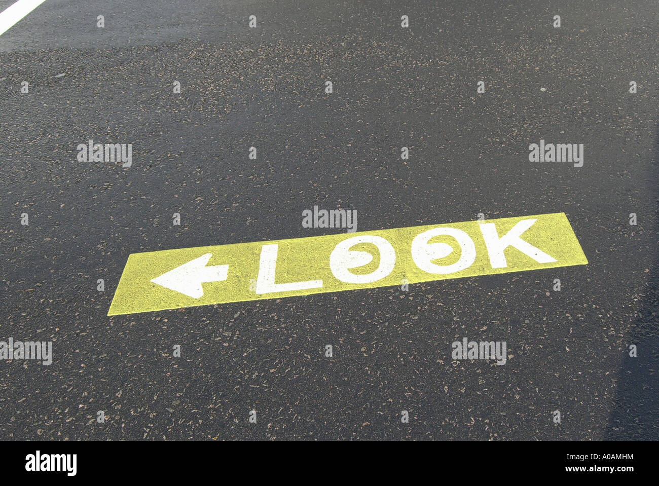 Look warning sign painted on pavement at city street intersection Stock ...