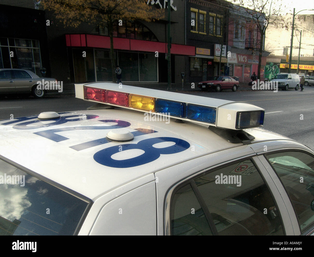 View of roof of police car with lightbar and gps pucks on city street ...