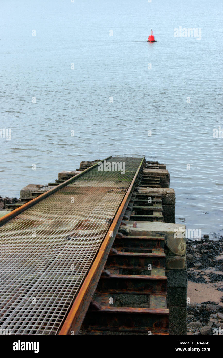 Slipway at seaside with red buoy in the distance Stock Photo - Alamy
