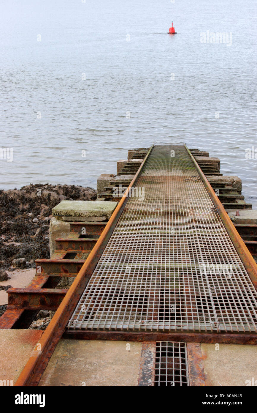 Slipway at seaside with red buoy in the distance Stock Photo - Alamy