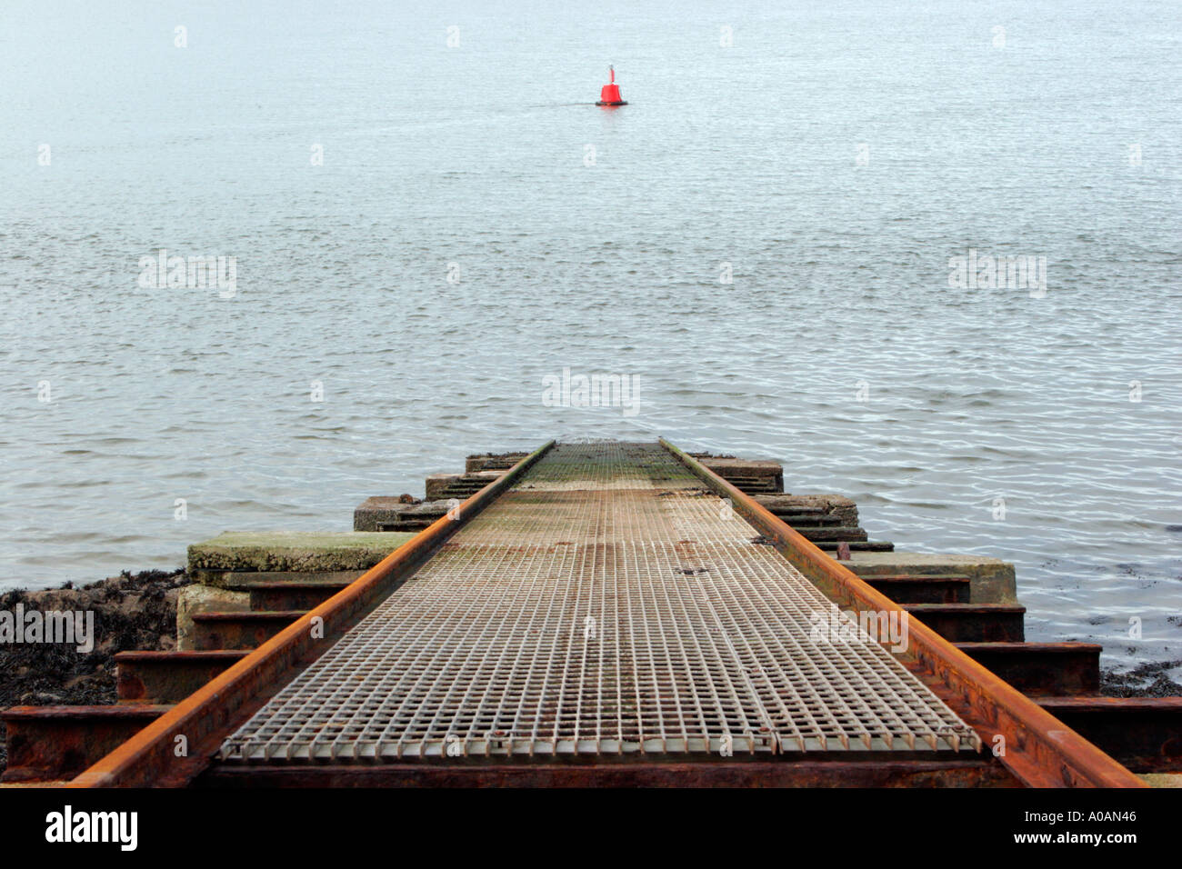 Slipway and red buoy Stock Photo - Alamy