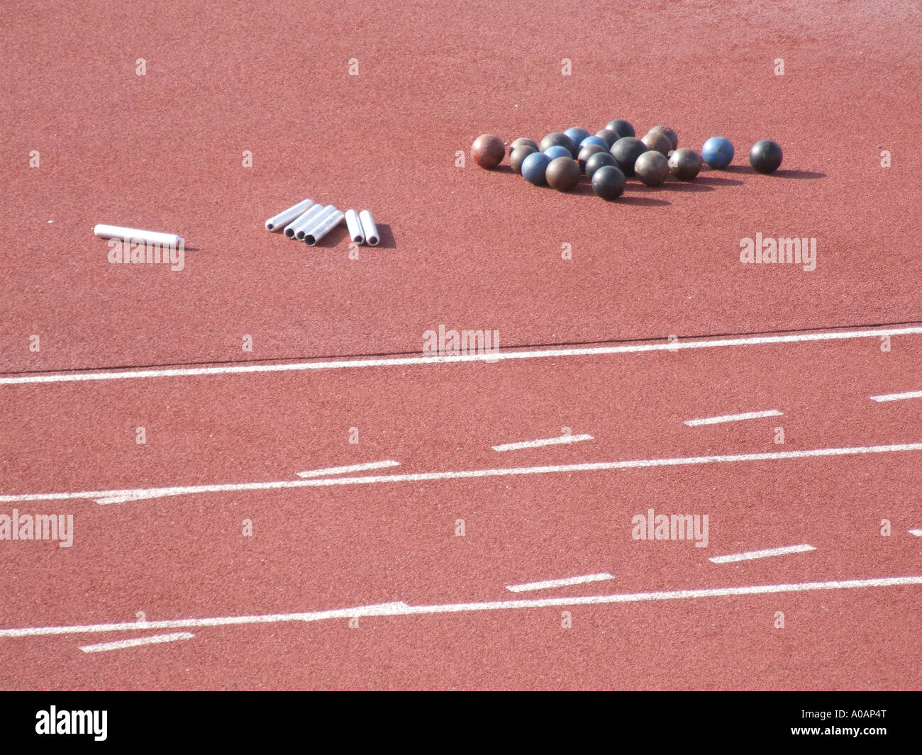 shot put and batons on athletics track Stock Photo - Alamy
