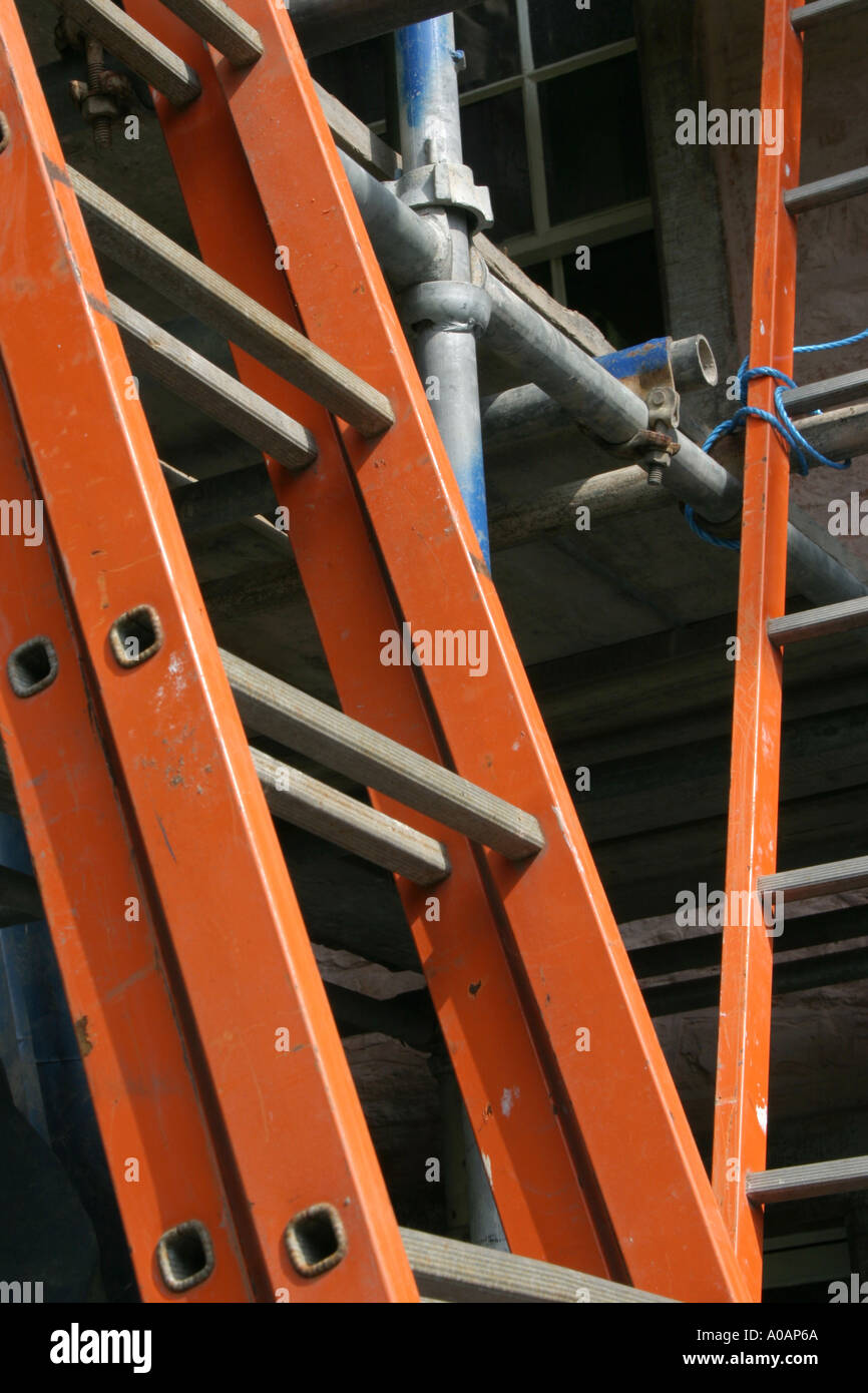 Orange ladders against scaffolding on building site Stock Photo - Alamy