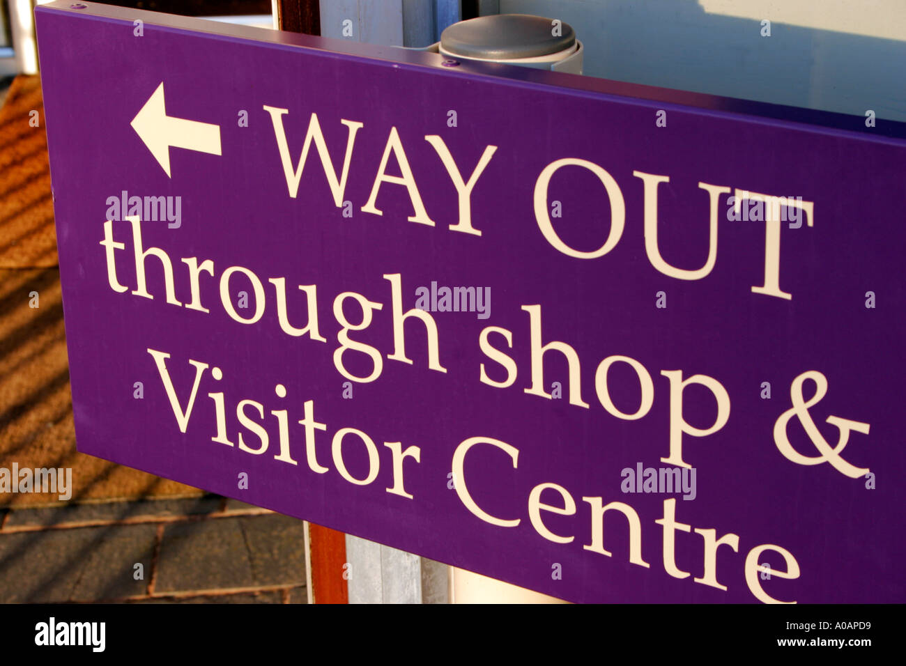 Purple exit sign showing way out through shop and visitor centre Stock ...