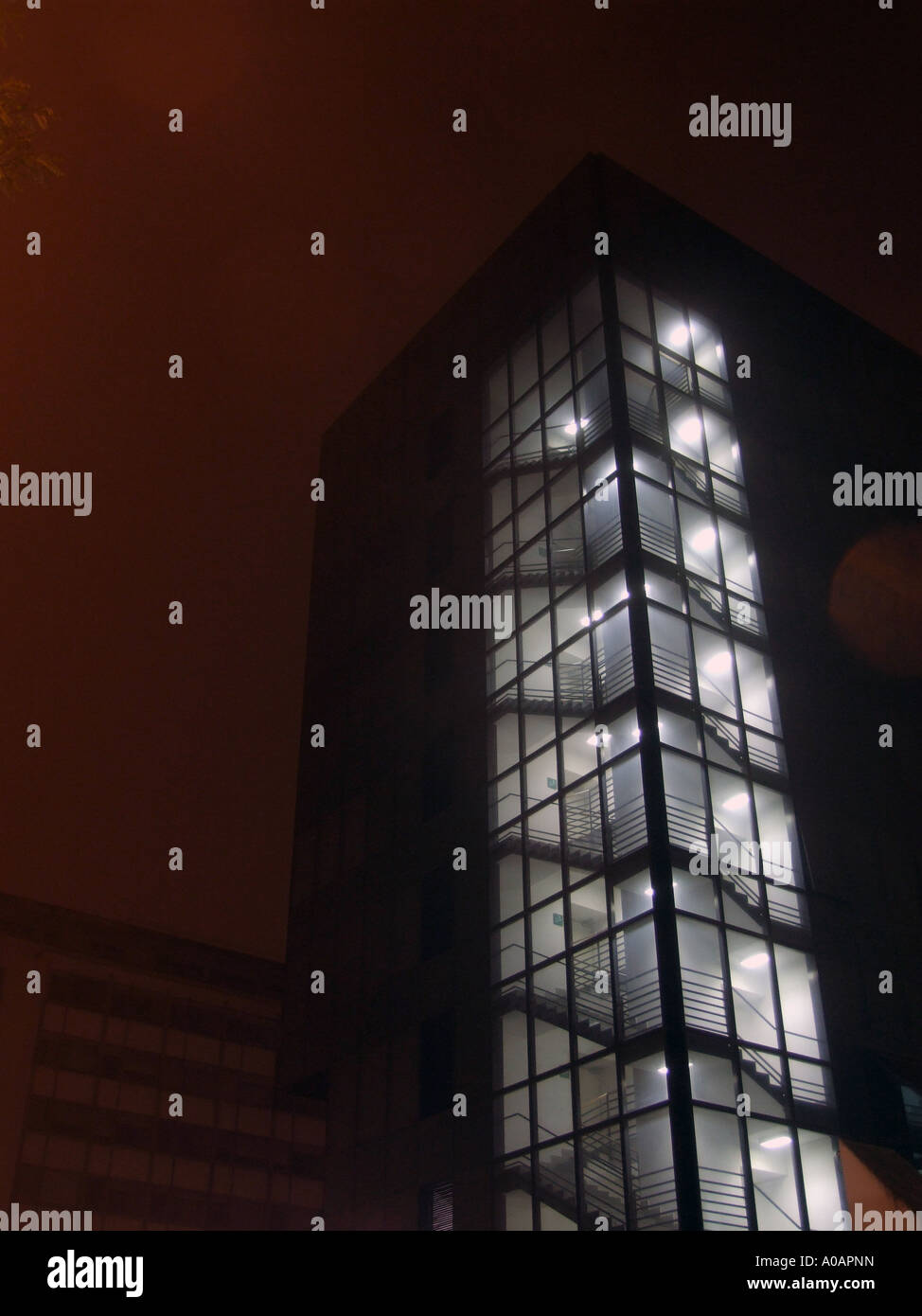 high rise building in fog at night Stock Photo - Alamy