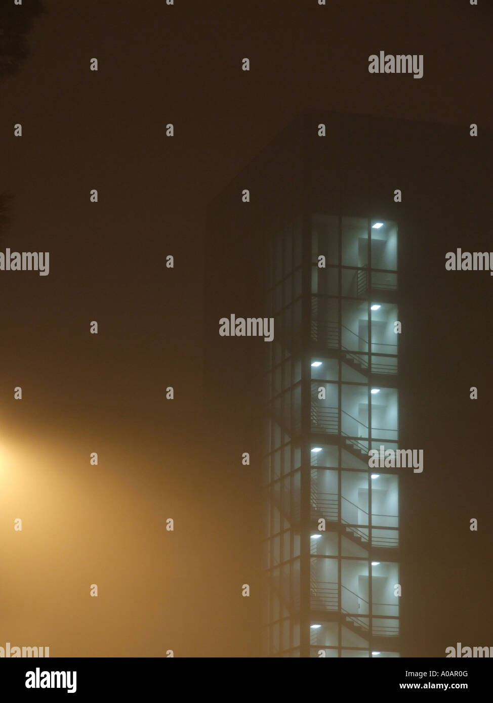 high rise building in fog at night Stock Photo - Alamy