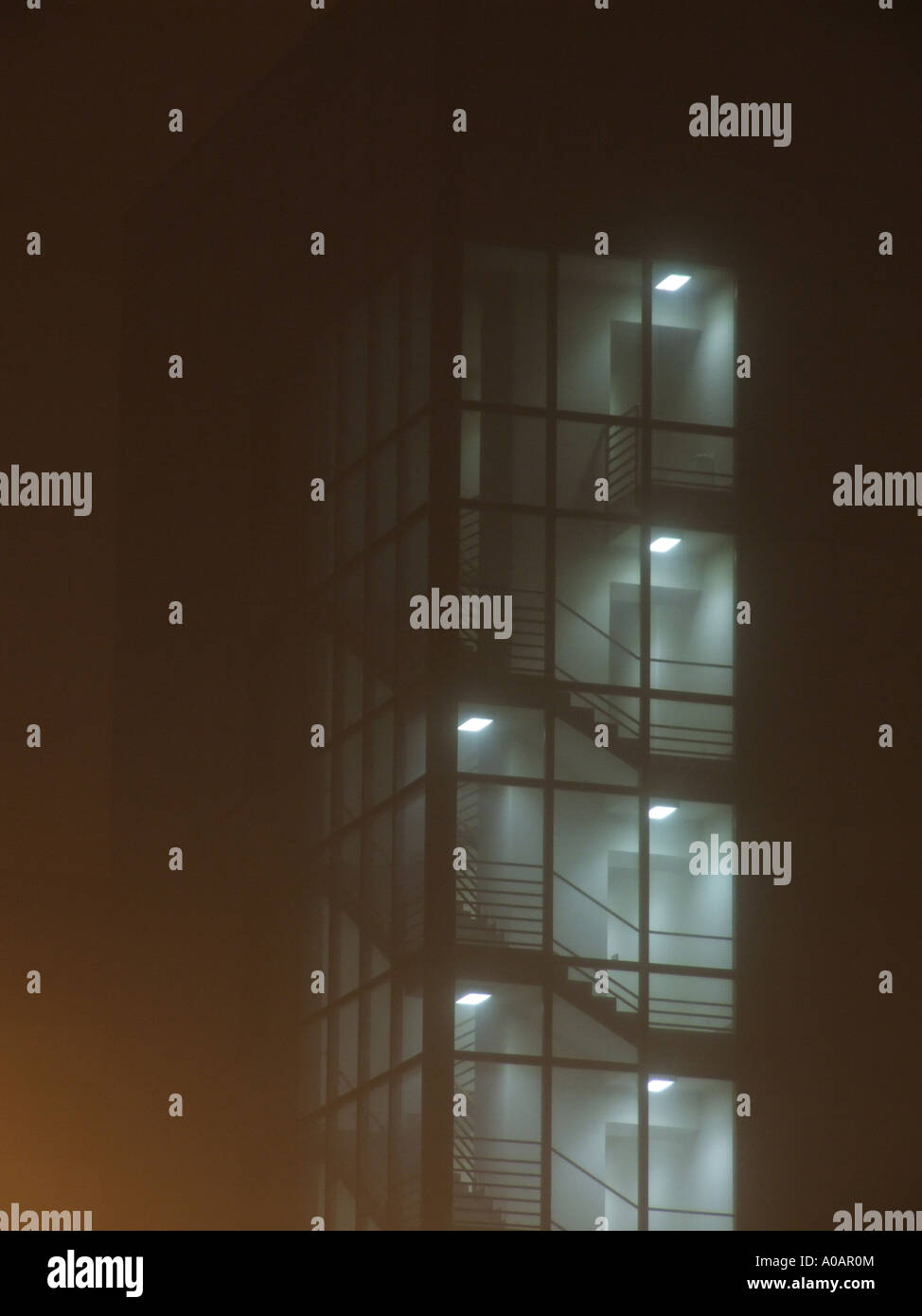 high rise building in fog at night Stock Photo - Alamy