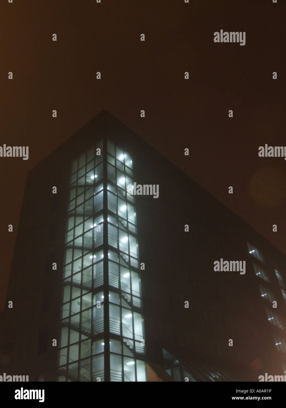 high rise building in fog at night Stock Photo - Alamy