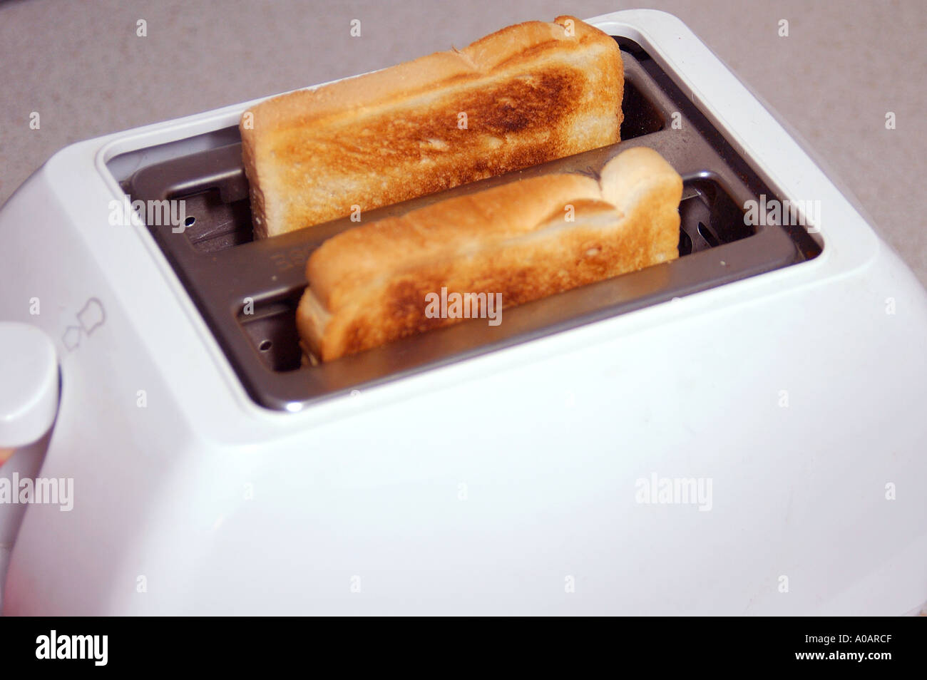 Toasted bread popped up in the toaster, Australia Stock Photo - Alamy