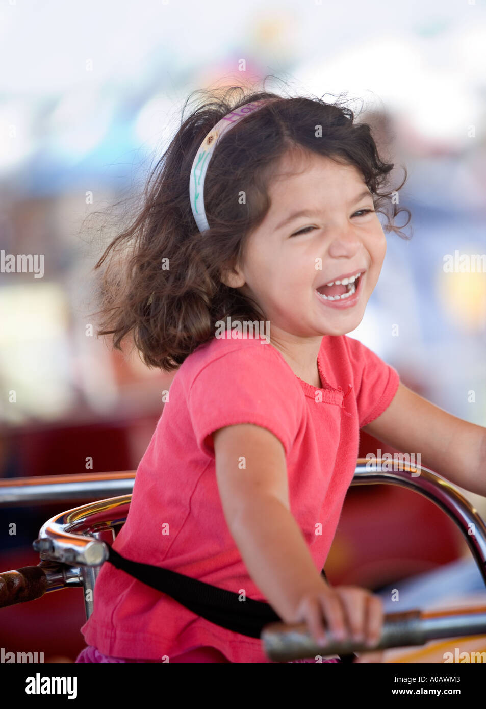 Portrait of girl on amusement ride at county fair Stock Photo - Alamy