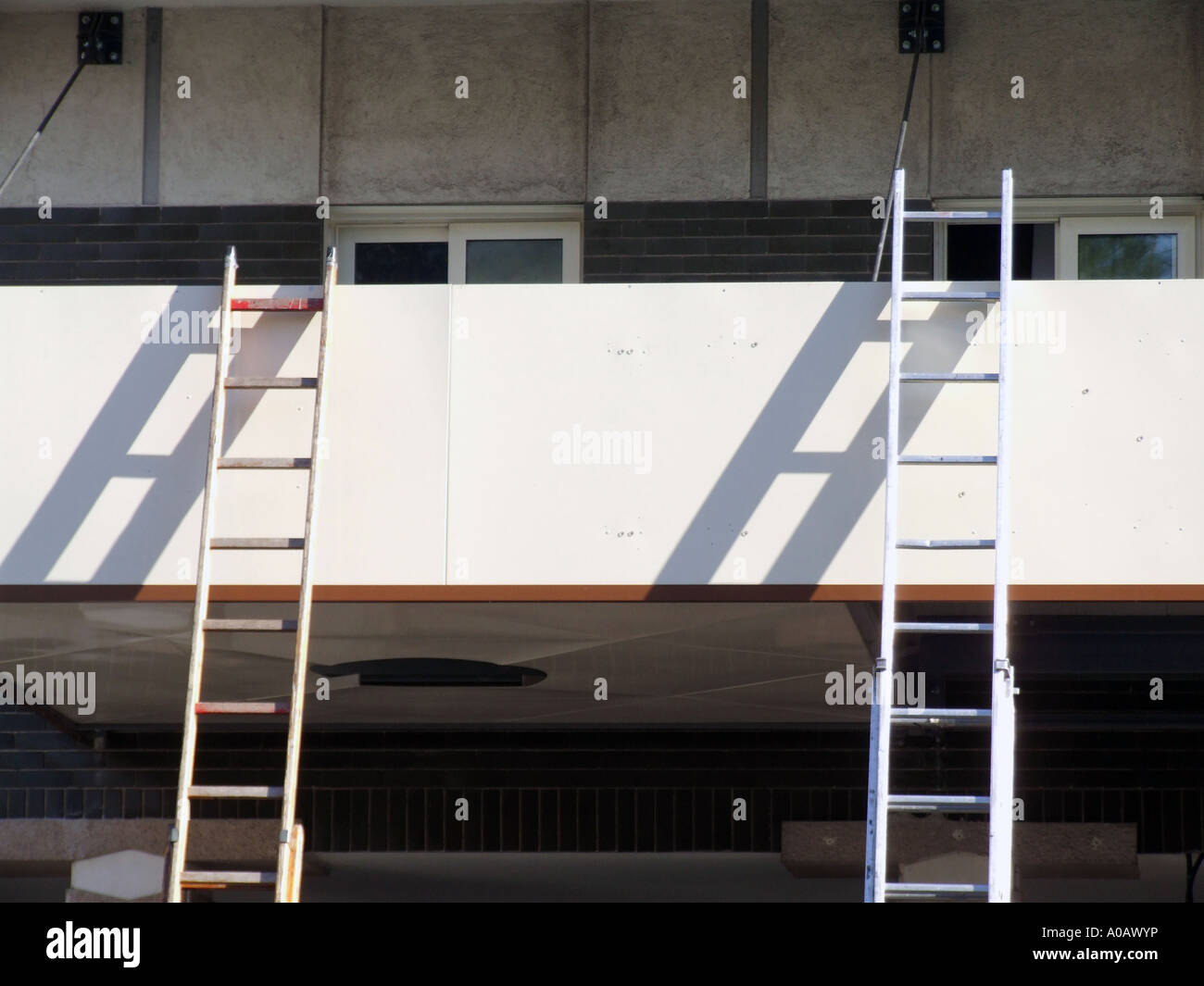 two ladders on building Stock Photo - Alamy
