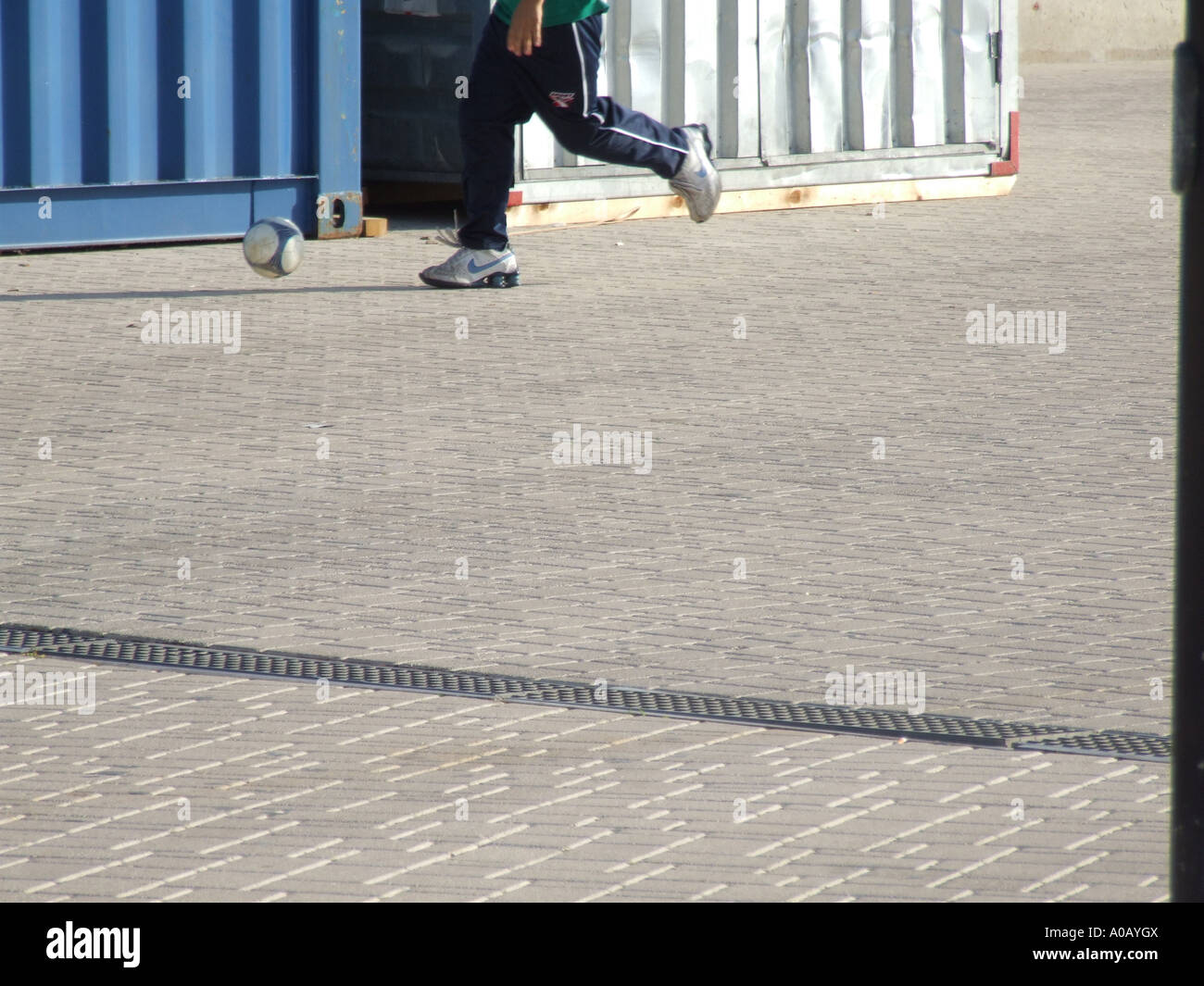 boy playing football in port Stock Photo - Alamy