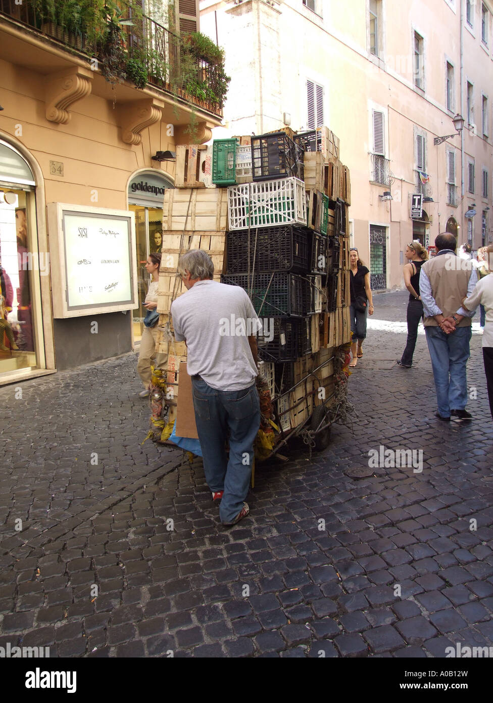 man pulling trolley full of boxes in rome Stock Photo - Alamy