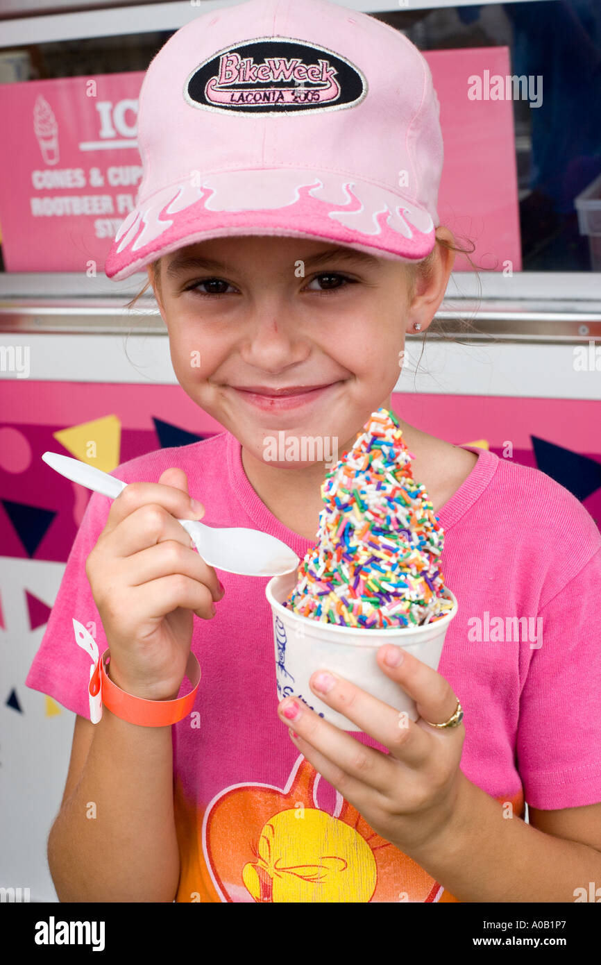Portrait Caucasian girl eating ice cream at county fair Stock Photo - Alamy