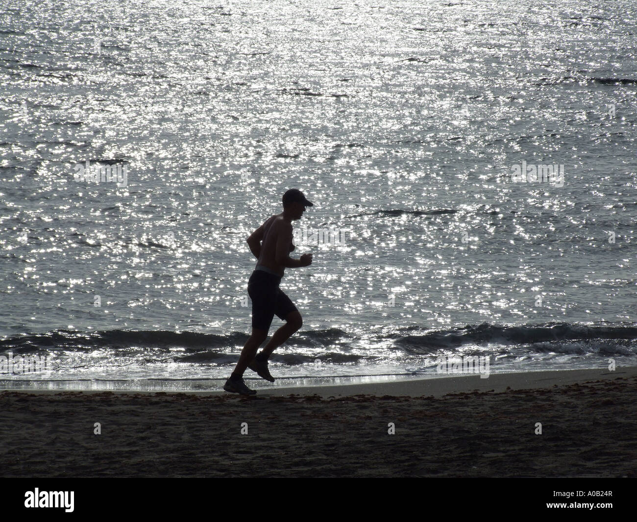 man running on beach Stock Photo - Alamy