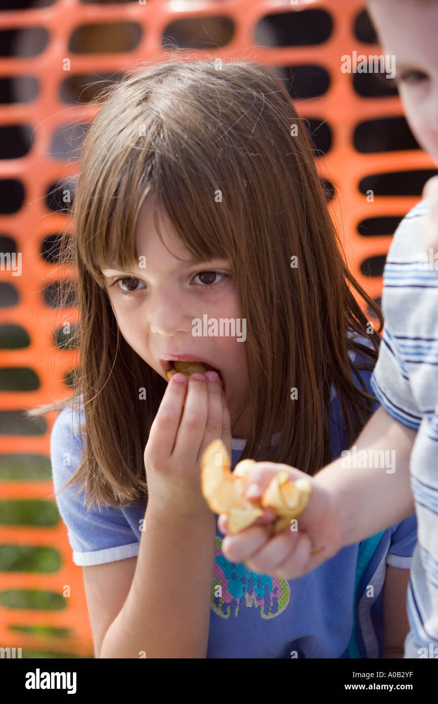 Portrait Caucasian siblings eating potato chips Stock Photo - Alamy