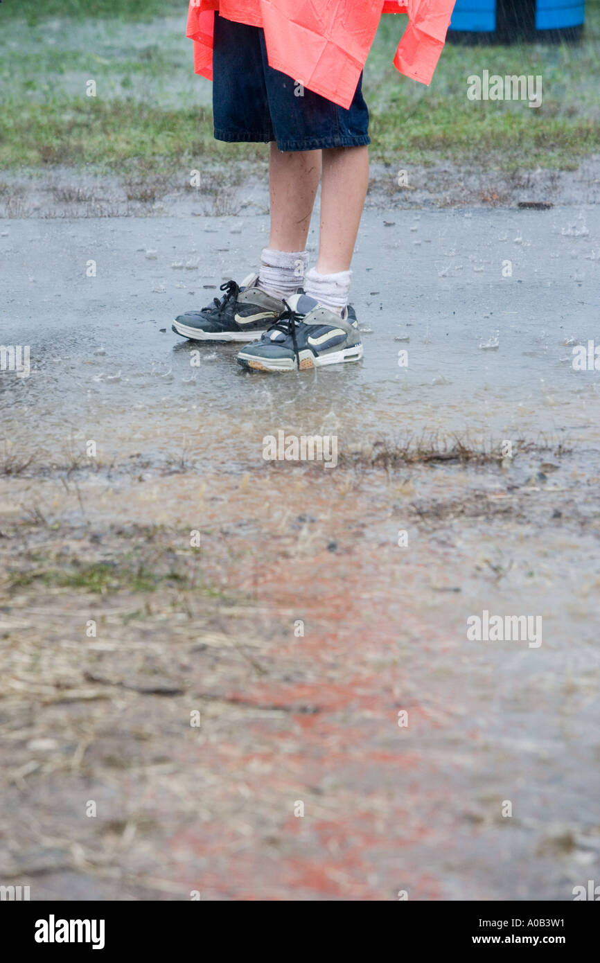 Portrait Caucasian boy getting drenched in storm Stock Photo - Alamy