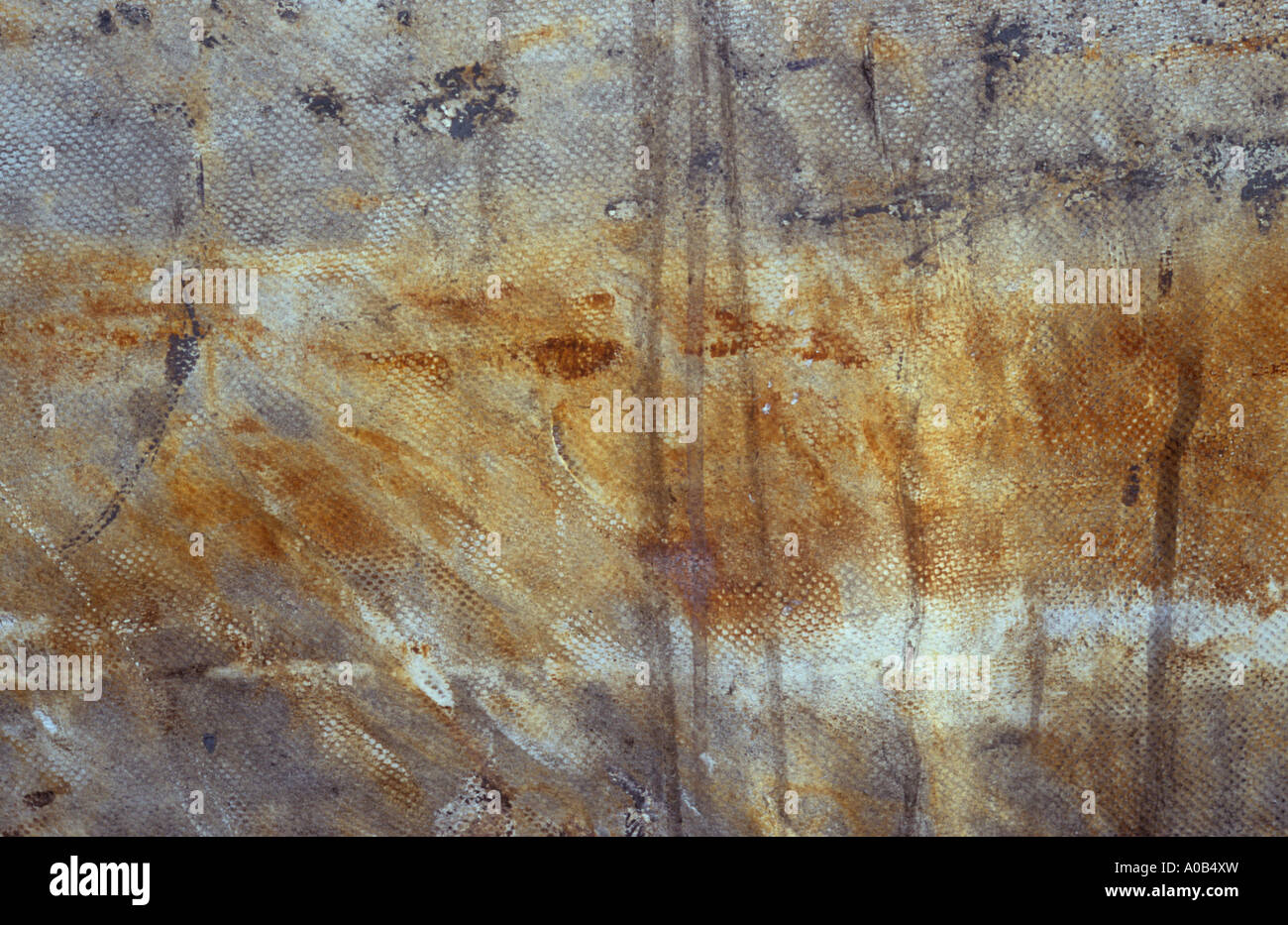 Detail of white plastic or nylon tarpaulin sheet with rust stains and ...