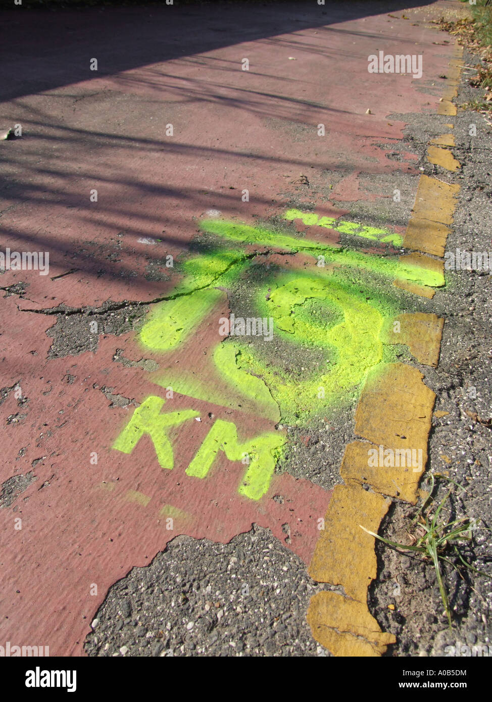 19 km painted on damaged empty cycle path lane Stock Photo - Alamy